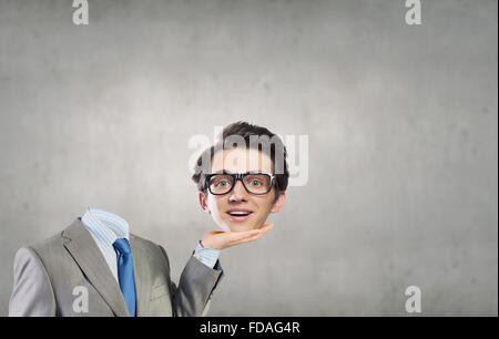 Young headless businesman holding his head in palm Stock Photo - Alamy