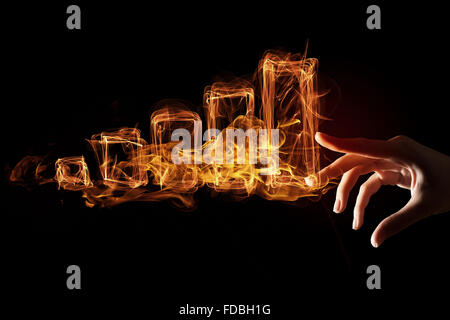 Hand touch fire glowing graph sign on dark background Stock Photo - Alamy