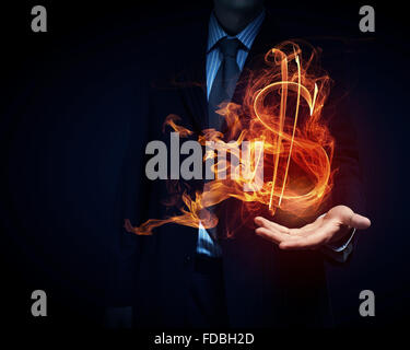 Burning dollar sign in businessman palm on dark background Stock Photo ...