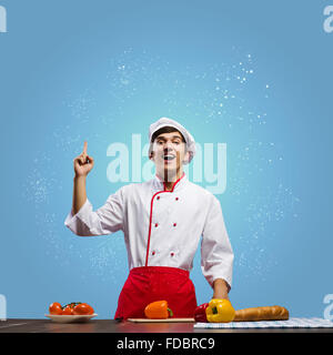 Young cheerful cook and ingredients flying in air Stock Photo - Alamy