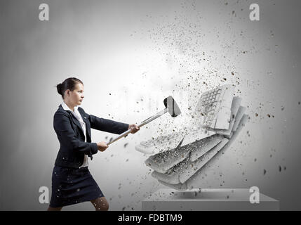 Businesswoman in anger crashing keyboard with hammer Stock Photo - Alamy