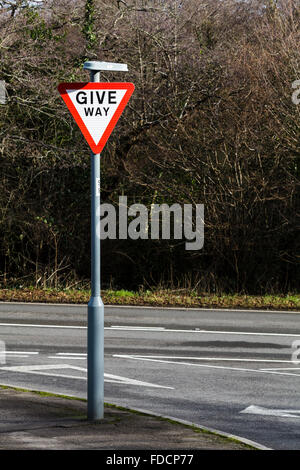 give way road sign on country lane joining main highway junction in ...