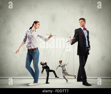 Image of man and woman with marionette puppets Stock Photo - Alamy