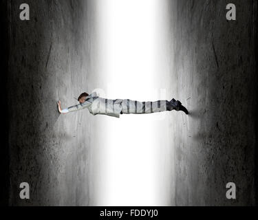 Young troubled businessman trapped between two walls Stock Photo - Alamy