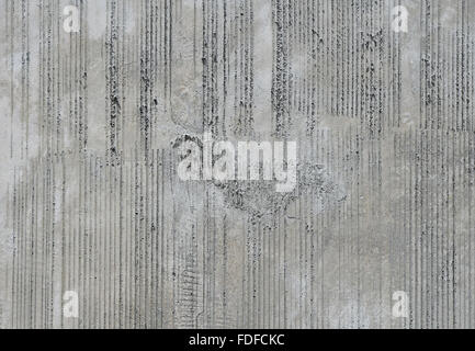Grey concrete wall with parallel traces from rubbed finish processing ...