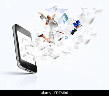 Image of businesswoman jumping out of mobile phone Stock Photo - Alamy