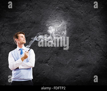 Young handsome businessman in fumes smoking pipe Stock Photo - Alamy