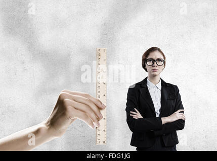 People hands measuring businesswoman with wooden rulers Stock Photo - Alamy