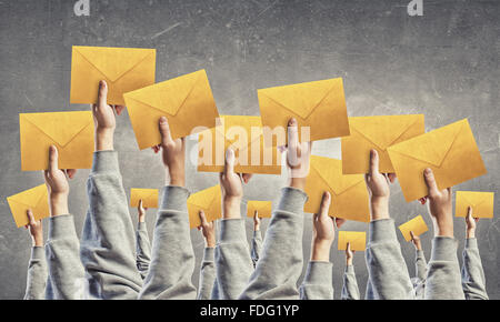 Crowd of businesspeople lifting up hands with conceptual cards Stock ...