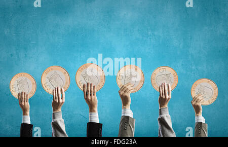 Crowd of people holding five euro coin Stock Photo - Alamy