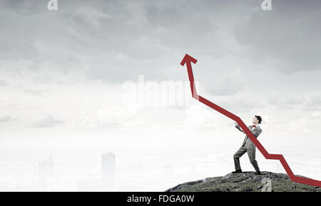 Businessman pulling arrow with rope and making it raise up Stock Photo ...