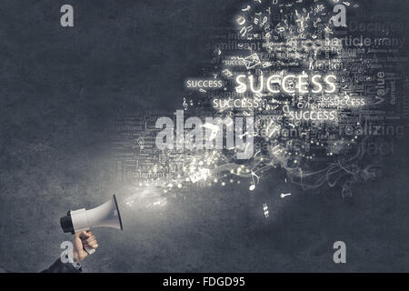 Businessman hand with loudspeaker and words flying out Stock Photo - Alamy