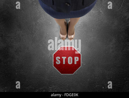 Top view of businesswoman feet and stop sign Stock Photo - Alamy