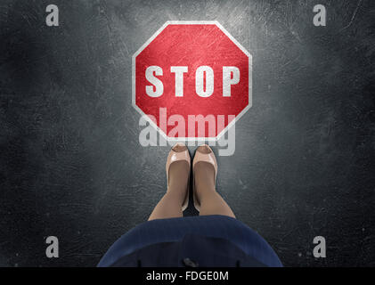 Top view of businesswoman feet and stop sign Stock Photo - Alamy