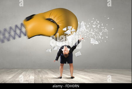 Boxing glove on spring striking group of businesspeople Stock Photo ...