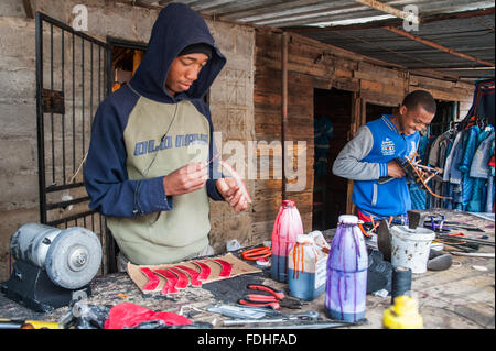 Young African Men making shoes at the Manzini Wholesale Produce and ...