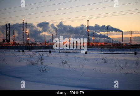 Refinery at sunset sky background. Frosty snowy winter evening Stock ...