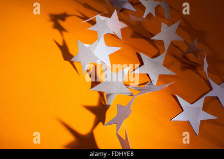 Paper stars group on a colour background Stock Photo - Alamy