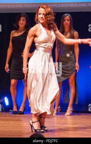 Female bodybuilder in evening dress, flexes her arm muscles Stock Photo ...