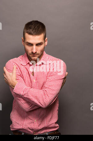 confident muscular man in studio. photo of muscular man with stubble ...
