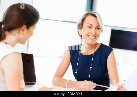 Female manager assessing work of her employees Stock Photo - Alamy