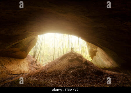sandstone cave entrance in dark. sand covered ground. latvia Stock ...