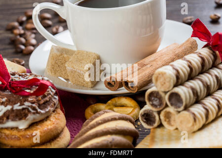 Assorted biscuits and sweets with a cup of coffee on table Stock Photo ...