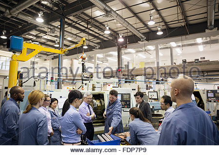 businessman and worker meeting in a factory - maintenance and repair of ...