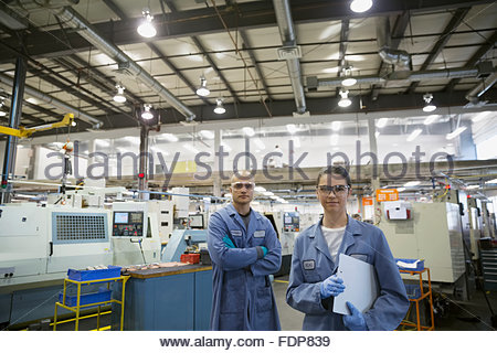 Portrait of confident workers in factory warehouse Stock Photo - Alamy