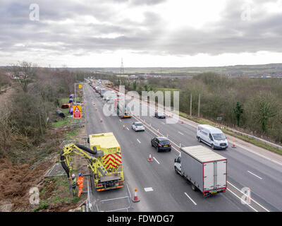 Workers on side of a coned off dual carriageway doing some vacuum ...