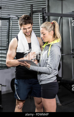 Smiling fit couple taking notes Stock Photo - Alamy