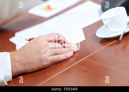 Image of businessman's hands laying on table with pen Stock Photo - Alamy