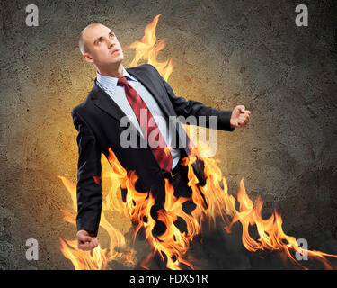 angry young business man with burning fire background Stock Photo ...
