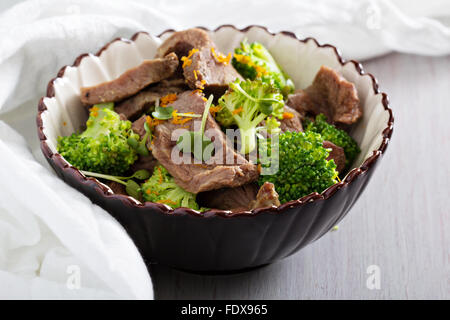 Beef and Broccoli Stir Fry with Zucchini in a skillet on textured dark ...