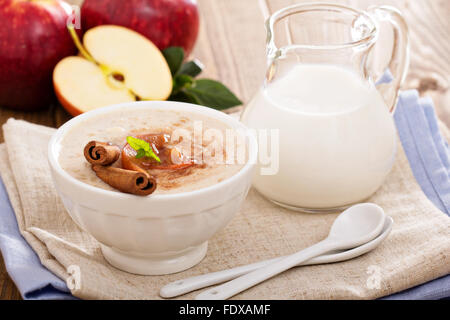 Bowl with delicious rice pudding and blueberries on black background ...