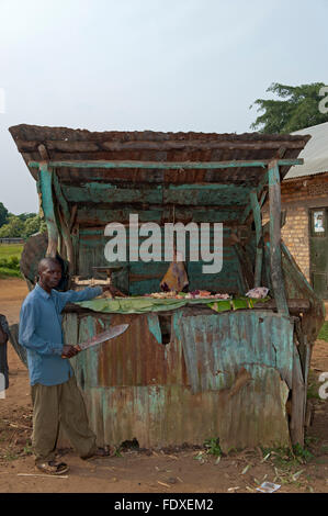 Ugandan butcher in his roadside shop made from tin sheets. Uganda Stock ...