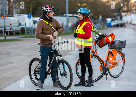 Cyclist put on safety clothing, bike helmet and reflecting vest for ...