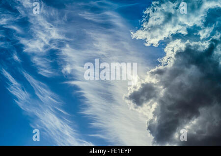 Heavy dark storm clouds covering the sky with patches of blue light ...