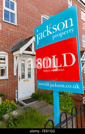 Sign: house sold by estate agent Reeds Rains, in springtime, England UK ...