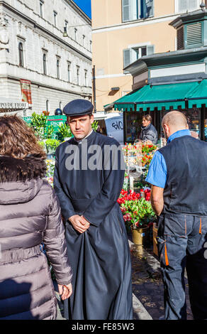 Catholic priest wearing cassock in confessional booth Stock Photo - Alamy