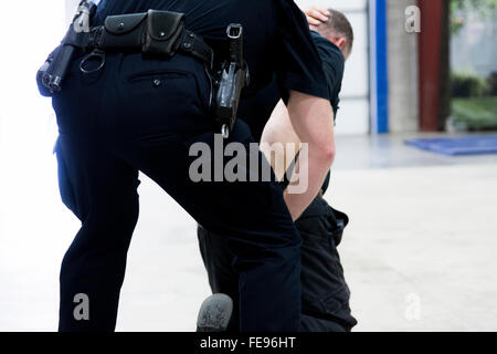 Police officer with handcuffs, arresting a suspect Stock Photo - Alamy