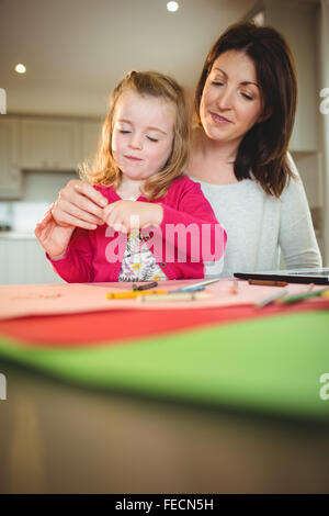 Portrait of cheerful mother and her daughter with paper shopping bags ...