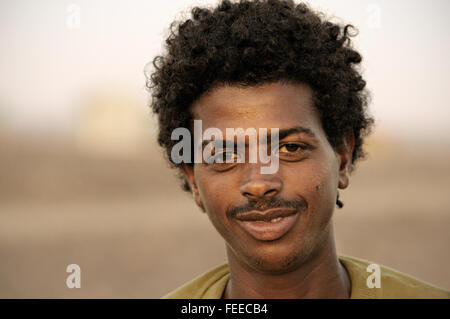 Portrait of a young Afar man with curly hair in Mille, Afar Region ...