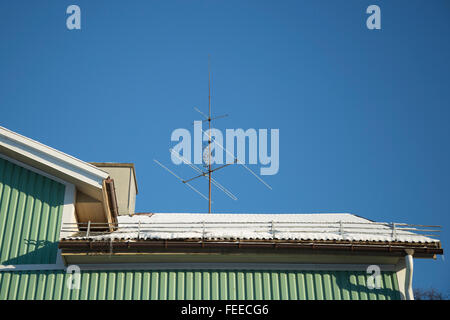 Television antenna covered with snow on a snow-covered roof Stock Photo ...