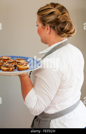 Woman preparing buns Stock Photo - Alamy