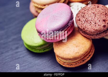 Row of different macaroons on a yellow pink background. Creative layout ...