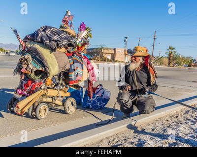 A homeless male character and his overloaded wheeled cart with his ...