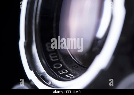 Close-up of a vintage 80mm camera lens made in Japan on white ...