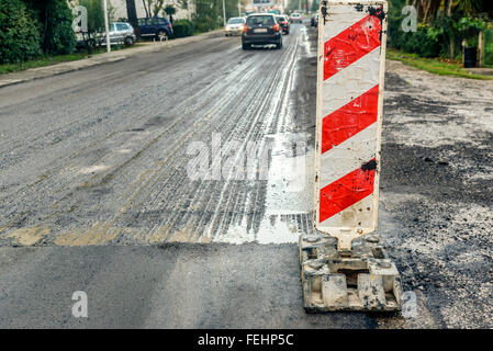 Road works marked with red and white striped road warning posts Stock ...