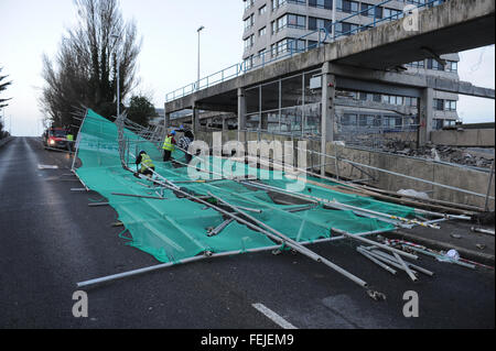 Workmen clear up fallen scaffolding brought down due to high winds ...